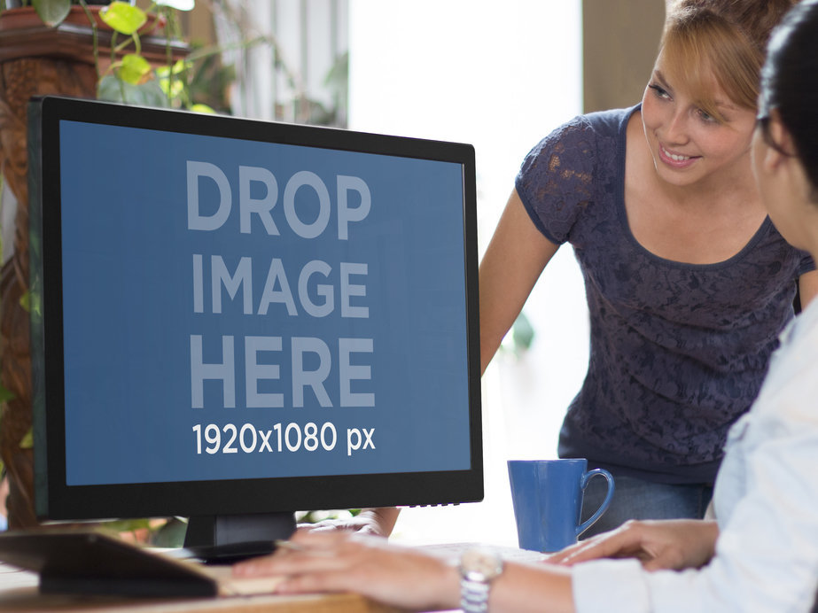 Placeit - Desktop PC Mockup Featuring Two Female Coworkers