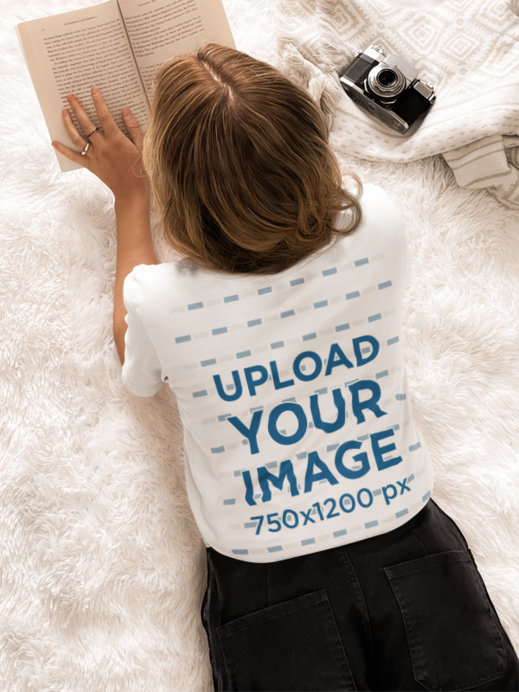 Placeit - Back-View T-Shirt Mockup of a Woman Reading a Book at Home