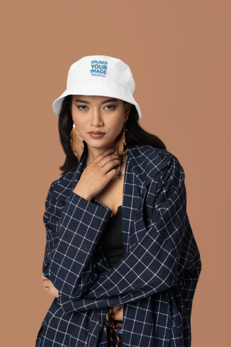 Placeit - Bucket Hat Mockup Featuring a Woman Posing With a Serious ...