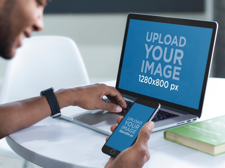 Placeit - Young Man Working on His MacBook Pro Laptop and iPhone Mockup