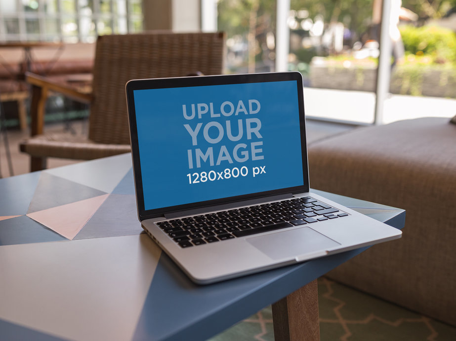 Placeit - Mockup Featuring a MacBook Standing on the Border of a Small ...