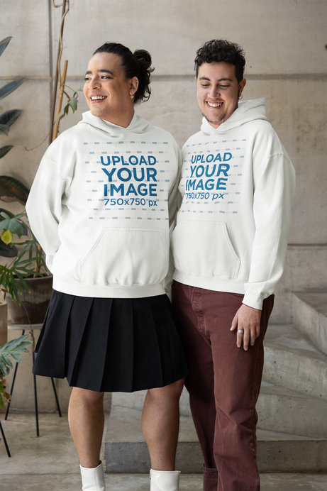 Placeit - Mockup of Two Friends Wearing Matching Gildan Pullover Hoodies