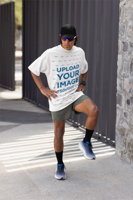 Placeit - Oversized Tee Mockup Featuring a Man Stretching Before a Run