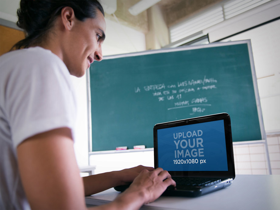 Placeit - Mockup Template of Male Student in Classroom Using an HP Laptop