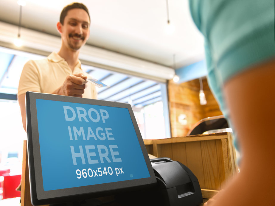 Placeit - Desktop Mockup of Cashier Taking Payment From Male Customer