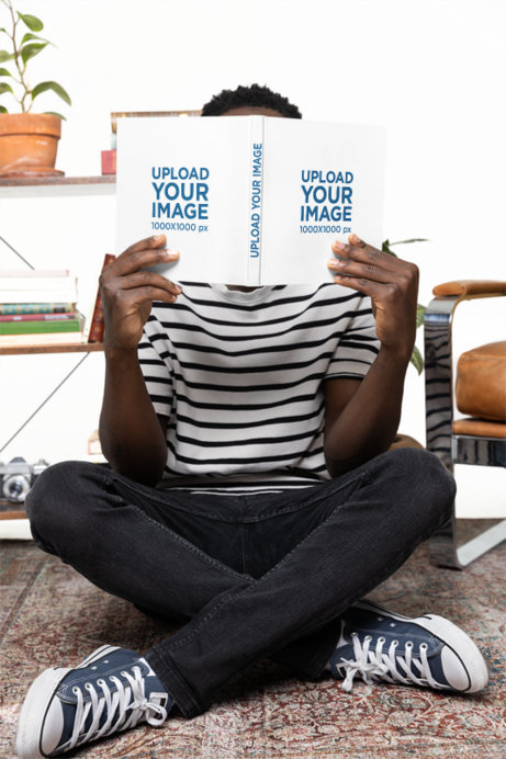 Placeit - Mockup of a Man Covering His Face With an Open Hardcover Book