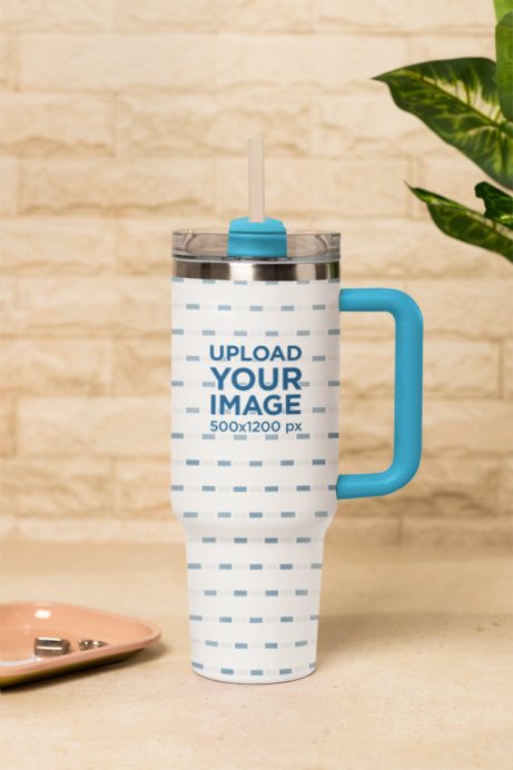Placeit - Mockup of a Sublimated Stanley Tumbler Placed on a Table With ...