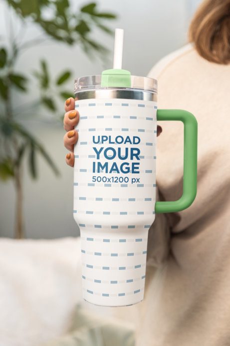 Placeit - Mockup of a Woman Holding a Sublimated Stanley Tumbler
