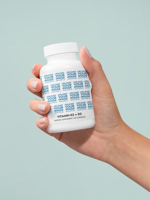 Placeit - Vitamin K2 + D3 Supplement Mockup Featuring a Woman's Hand