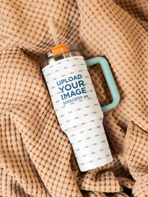Placeit - Mockup of a Stanley Tumbler Placed on a Cozy Blanket
