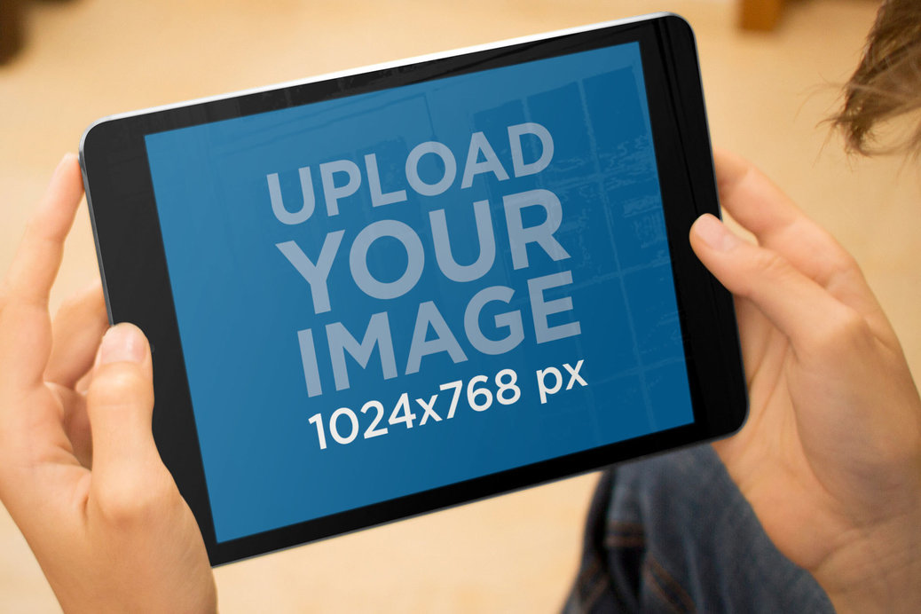 Placeit - Tablet Mockup of a Young Boy Using an iPad Mini at Home