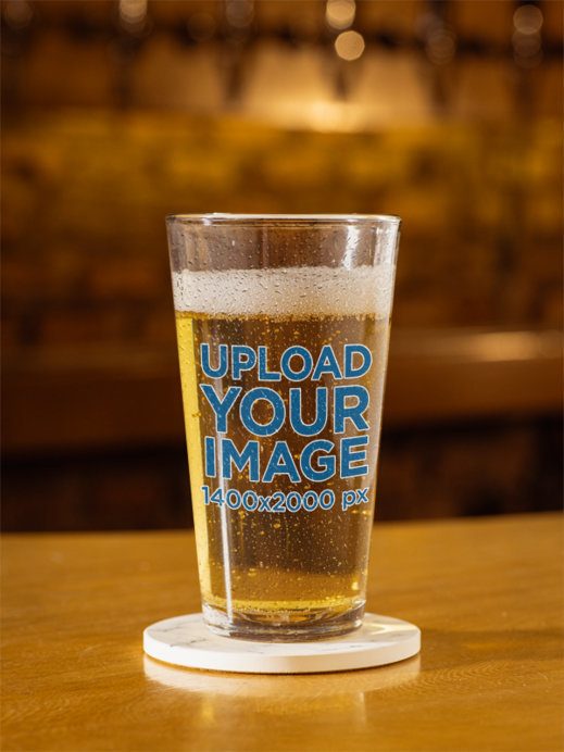 Placeit - Mockup of a Shaker Pint Glass Filled With Beer in a Bar Counter