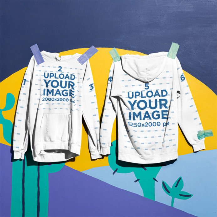 Placeit - Comfort Colors 1567 Mockup of Two Hoodies Pinned on a Mural Wall