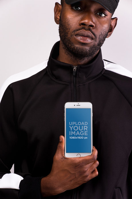 Placeit - iPhone 8 Plus Mockup Held by a Serious Man Wearing Black