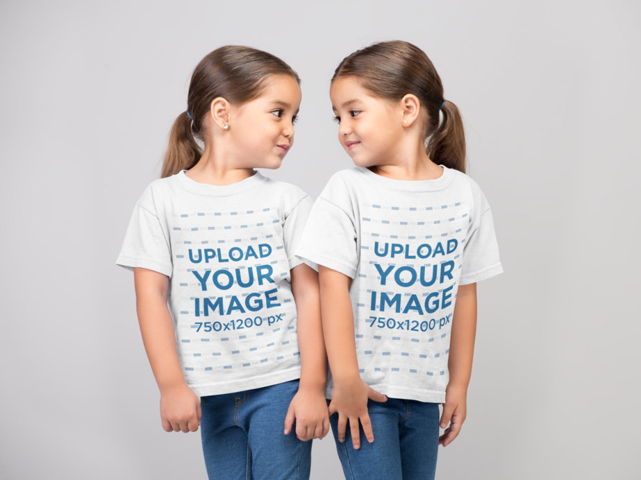 Placeit - Mockup of Two Little Girls Wearing Tshirts in a Photo Studio