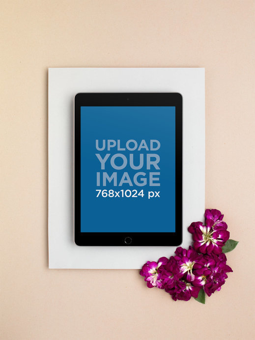 Placeit - iPad Mockup Over a Neutral Backdrop Bordered by Colored Flowers