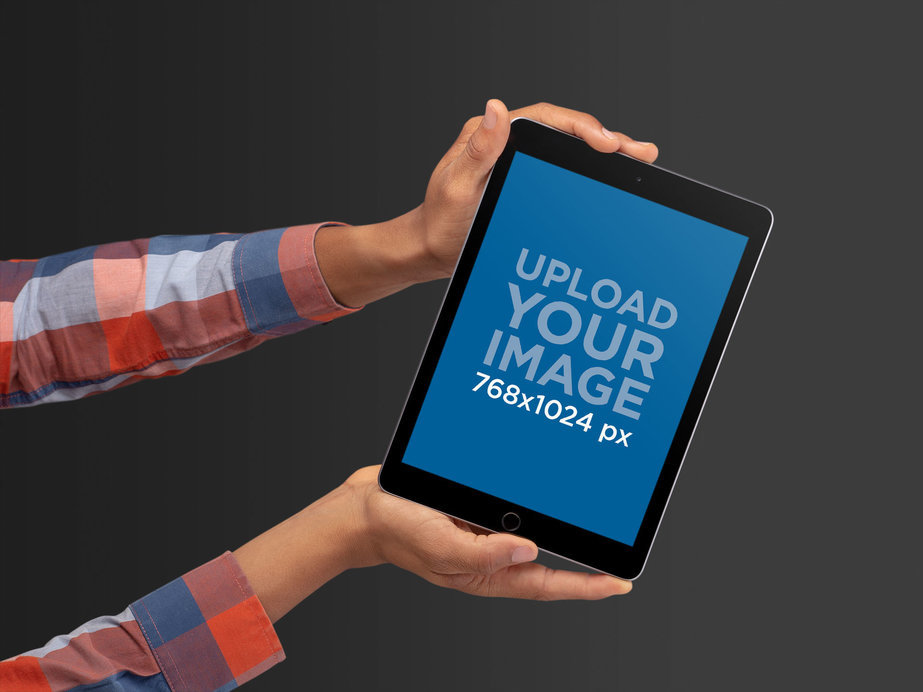 Placeit - Mockup of a Man with a Plaid Shirt Holding Up a Space Gray iPad