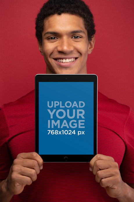 Placeit - iPad Mockup Being Held by a Man in a Dark Red Environment
