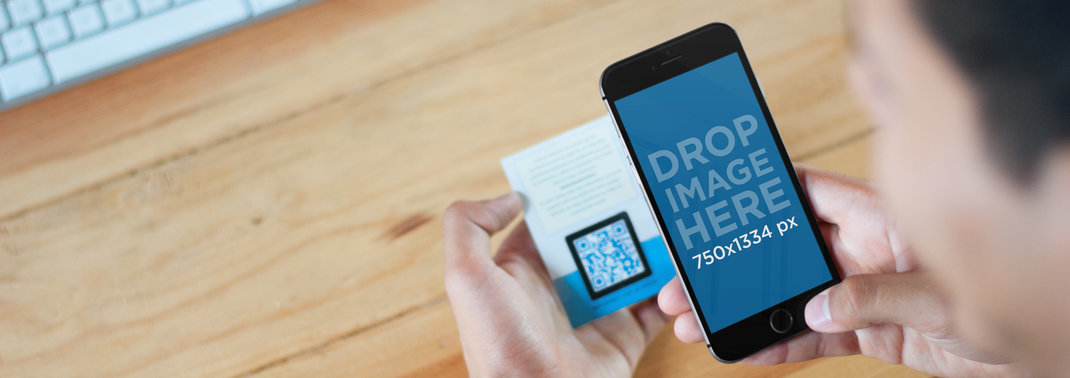 Placeit - Mockup of a Young Man Scanning a QR Code with an iPhone 6