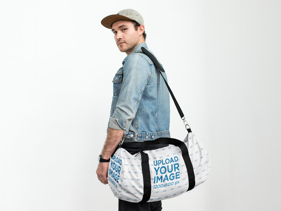 Placeit - Duffle Bag Back View Mockup of a Man at a Studio