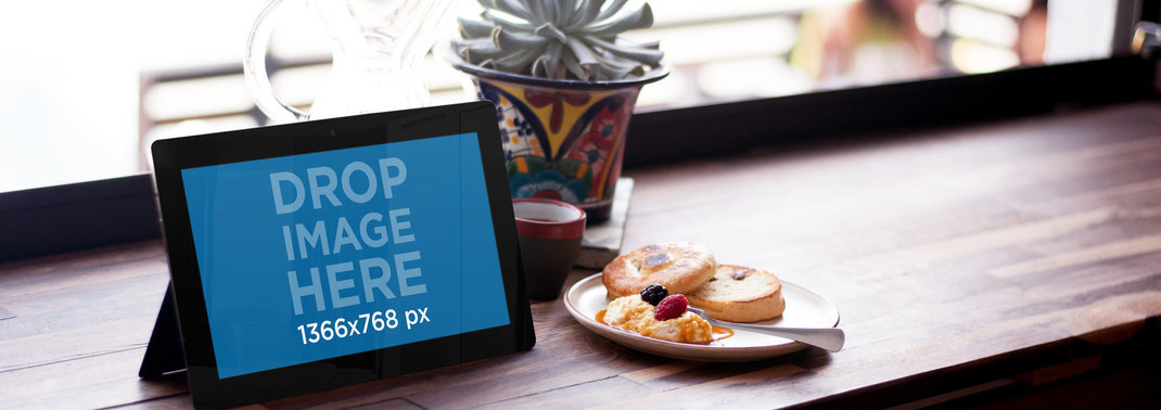 Placeit - Mockup of a Windows Tablet on a Restaurant Table