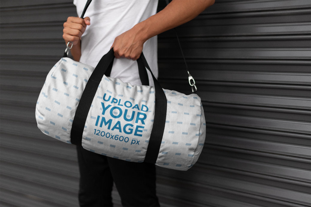 Placeit - Mockup of a Man Holding a Kit Bag