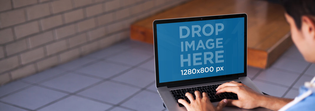 Placeit - Laptop Mockup of a Kid Using His Macbook at School