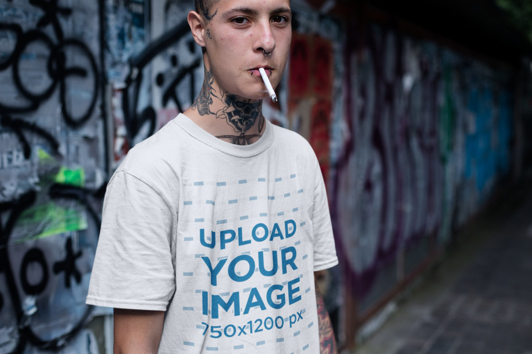 Placeit - T-Shirt Mockup of a Punk Man with Tattoos Smoking in Urban ...