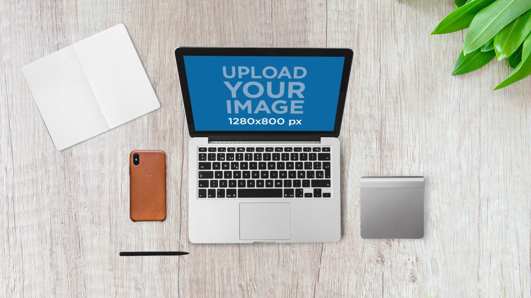 Placeit - Flat Lay MacBook Pro Mockup Featuring a Desk Environment