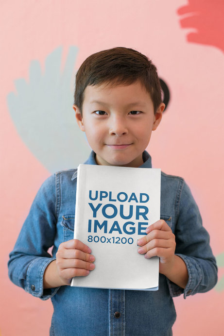 Placeit - Back to School Book Mockup of a Happy Kid Showing off His Book