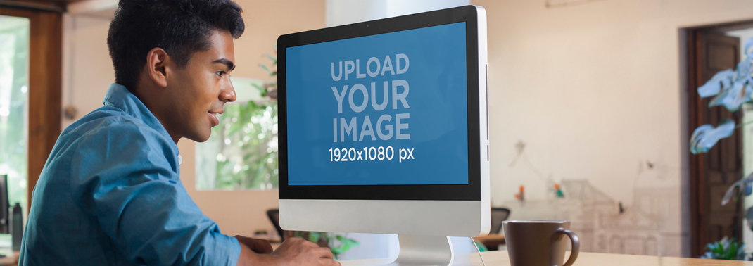 Placeit - Mockup of a Young Male Designer at a Creative Office