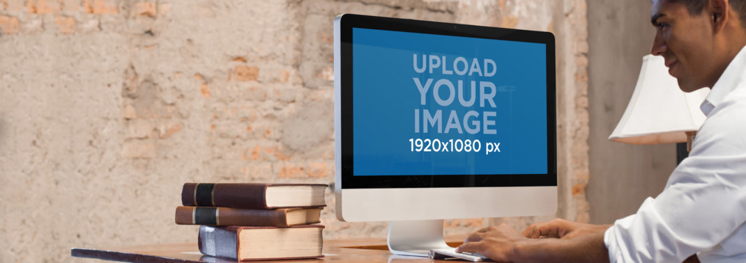 Placeit - Mockup of a Young Law Intern Using an iMac at Work