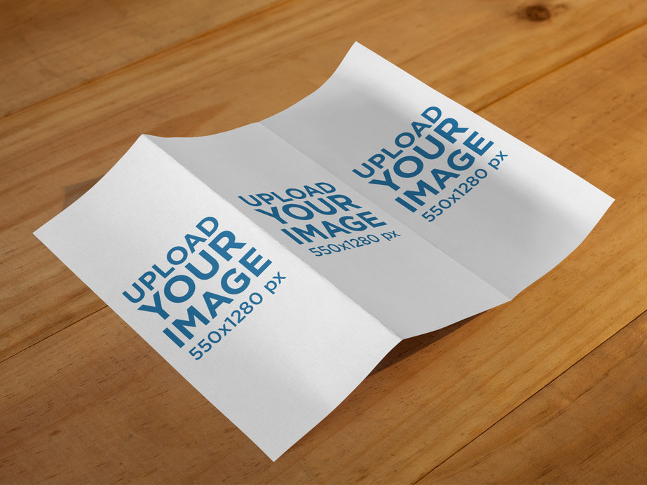 Placeit - 3 Panel Brochure Lying Open on Top of a Wooden Table Mockup