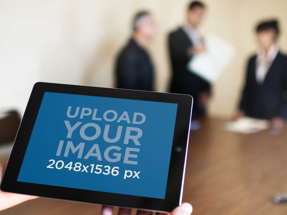Placeit - Mockup of Someone Holding an iPad in a Conference Room