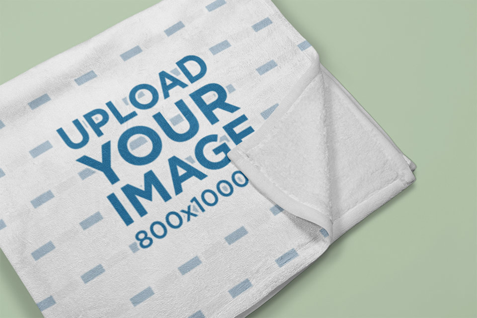 Placeit - Mockup of a Folded Throw Fleece Blanket in a Colored Surface