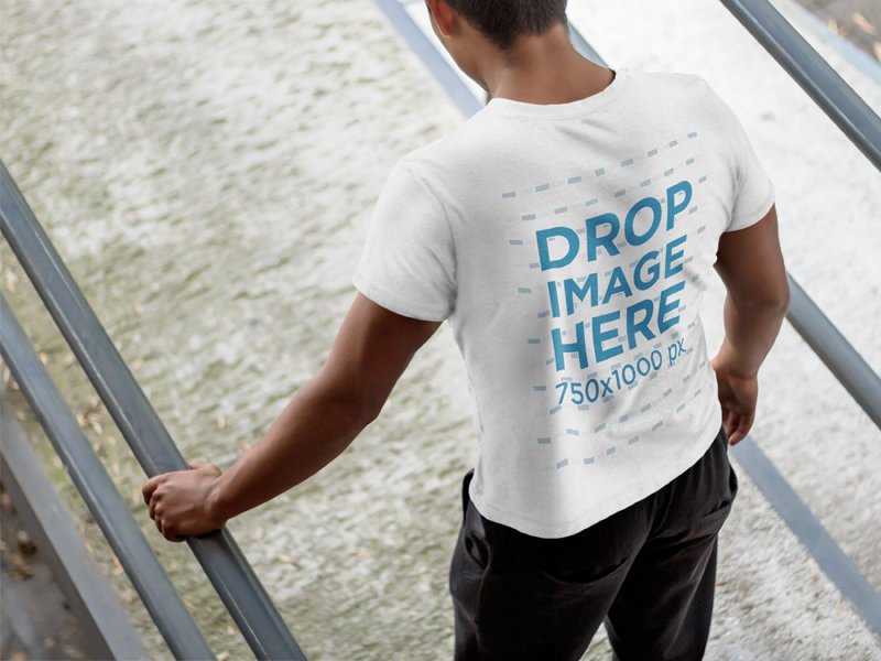 Placeit - T-Shirt Mockup of a Young Man Walking Down a Ramp