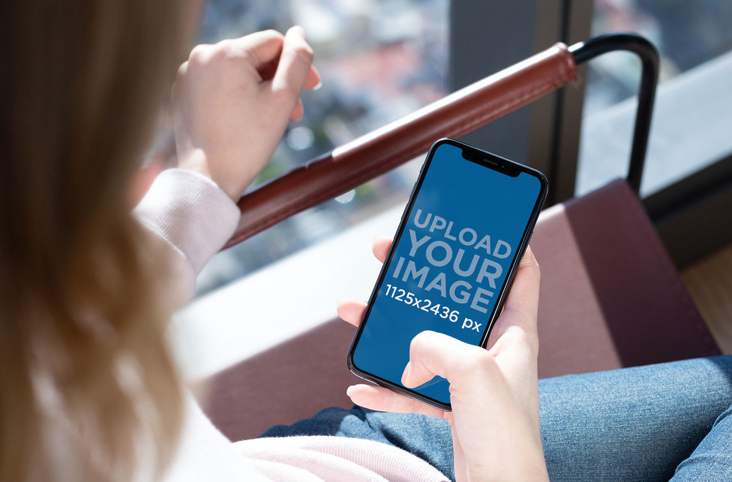Placeit - Over-The-Shoulder iPhone 11 Pro Mockup of a Woman Sitting on ...