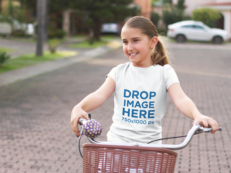 Placeit - T-Shirt Mockup Featuring a Young Girl Riding a Bicycle