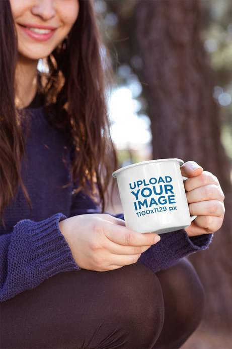 Placeit - 12 oz Enamel Mug Mockup Featuring a Smiling Woman at the Woods