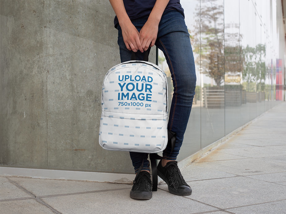 Placeit - Backpack Mockup Featuring a Teen Against a Glass Building