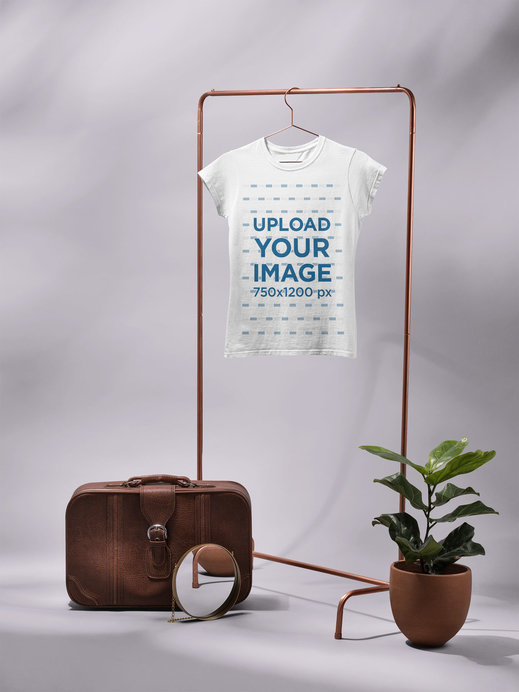 Placeit - Mockup of a Shirt Hanging in a Clothing Rack in a Studio