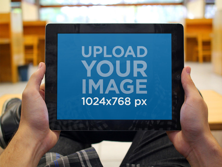 Placeit - Mockup of a Man Holding an iPad at a Library