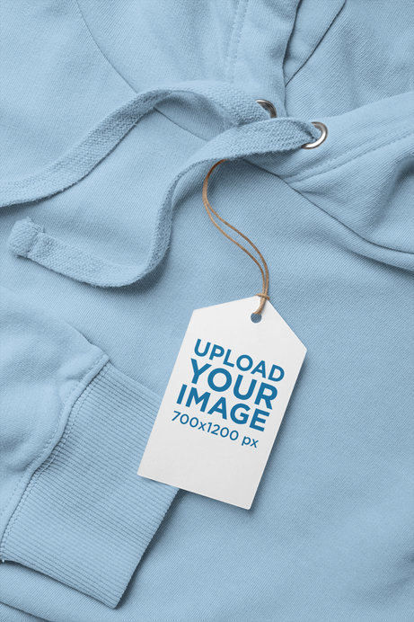 Placeit - Mockup of a Clothing Tag Lying on a Hoodie