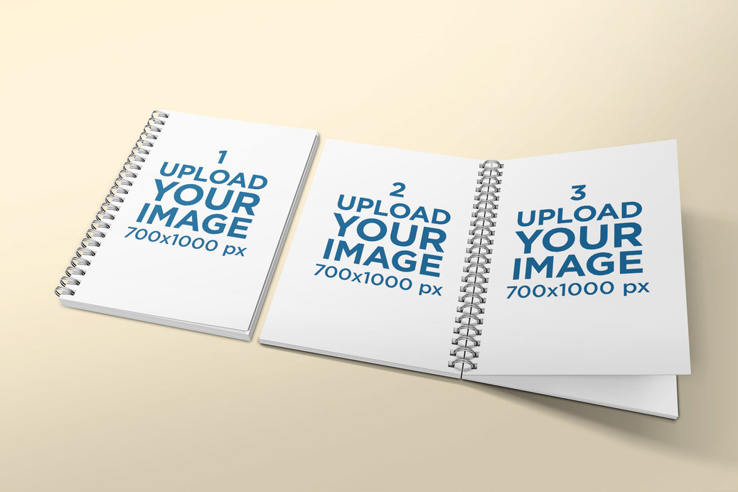 Placeit - Mockup Featuring an Open A5 Notebook Lying Next to a Closed One