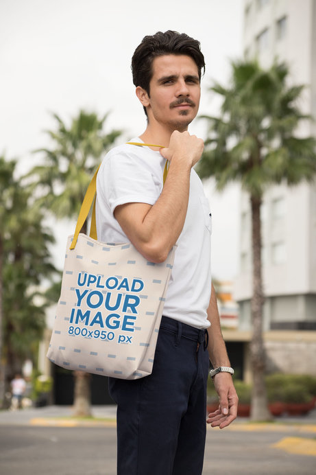Placeit - Mockup of a Man Carrying a Tote Bag in the City