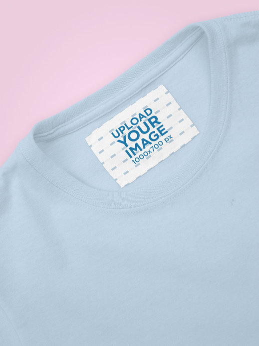 Placeit - Clothing Label Mockup Featuring a Sweatshirt on a Flat Surface