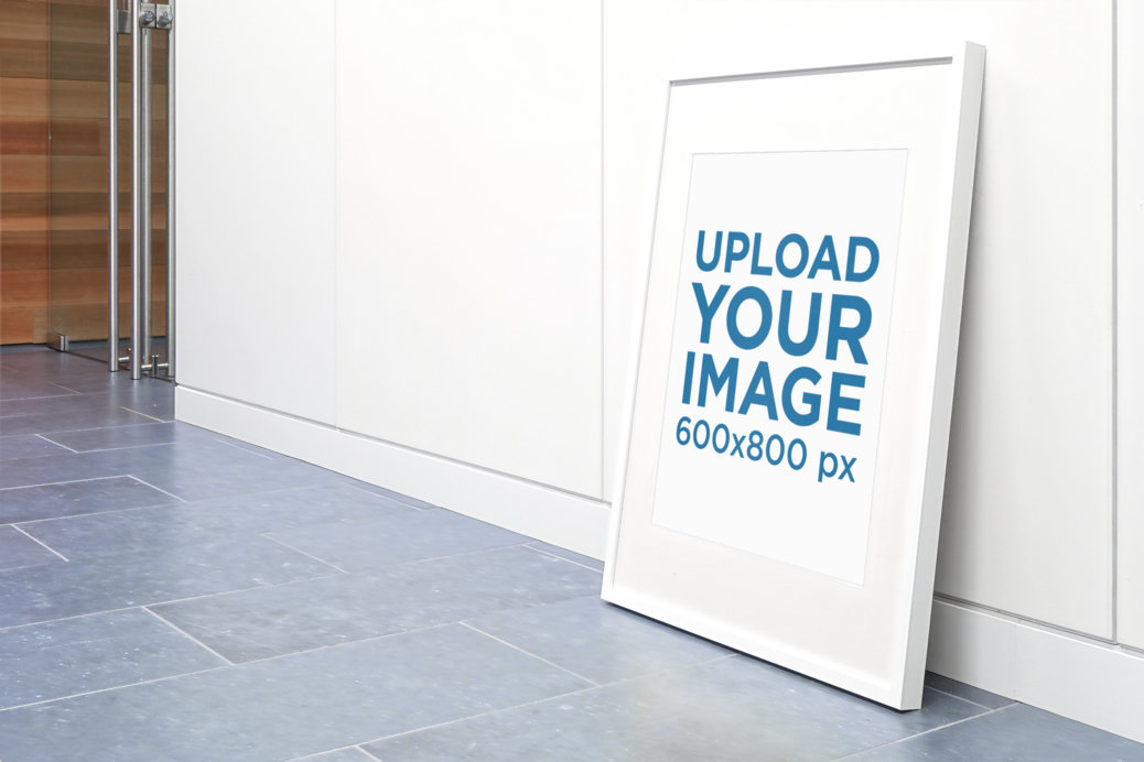 Placeit - Mockup Featuring a Poster Frame Standing on a Corridor's Floor