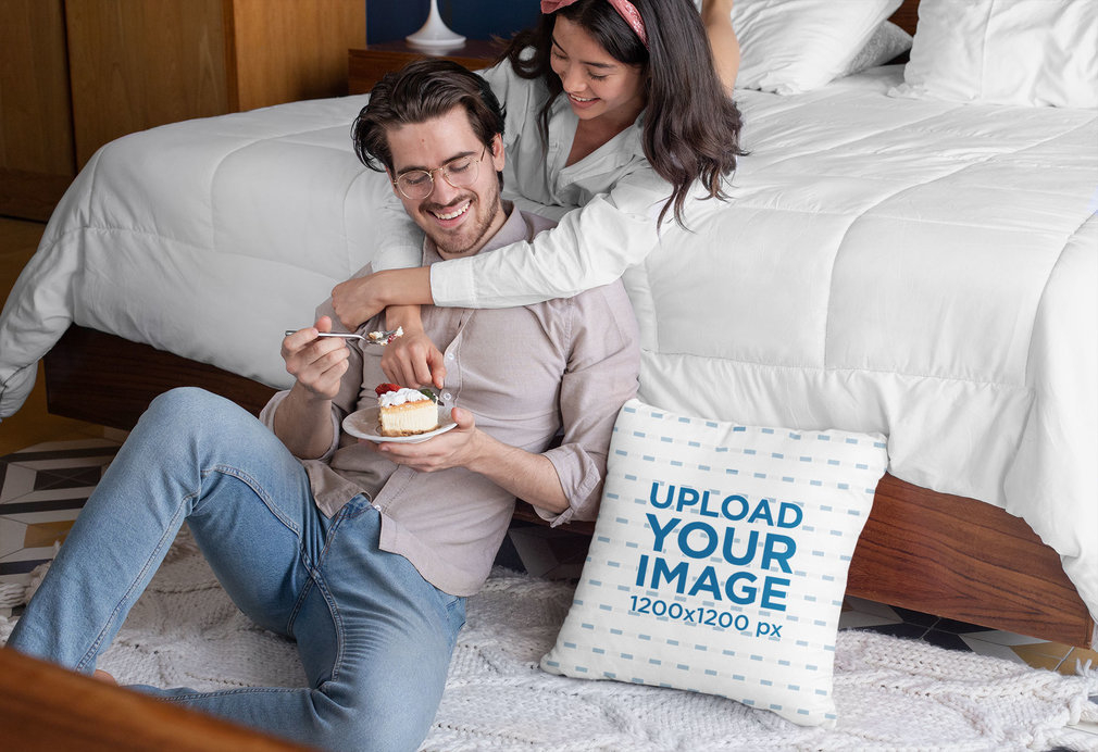 Placeit - Pillow Mockup of a Couple Eating a Pie in the Bedroom