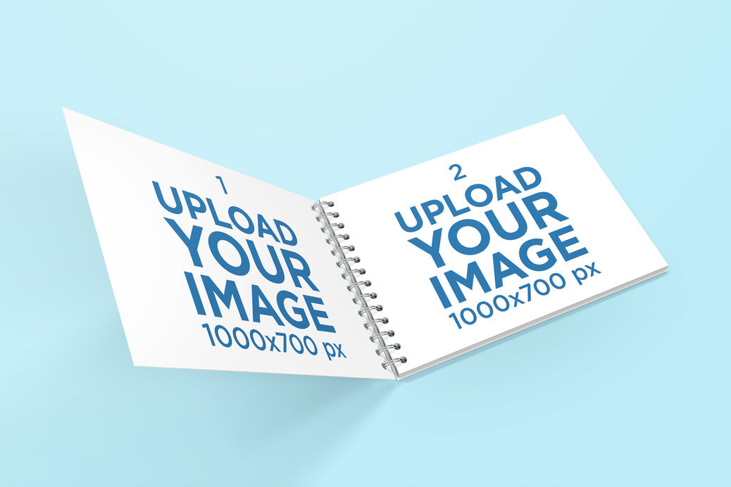 Placeit - Mockup Featuring an Opened Spiral Notebook Against a Plain ...