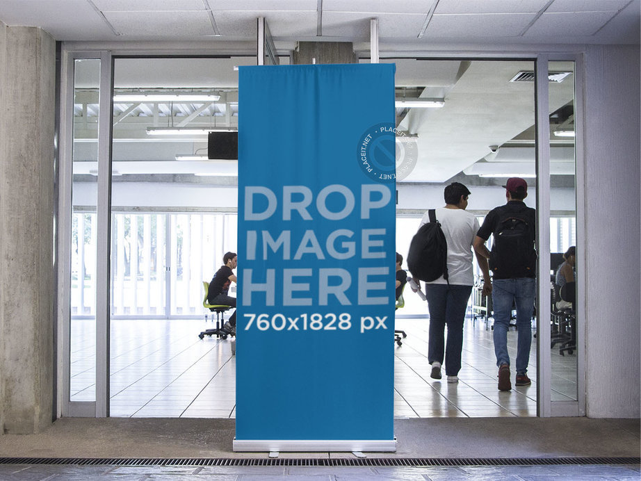 Placeit - Vertical Banner Mockup Standing Outside a Classroom